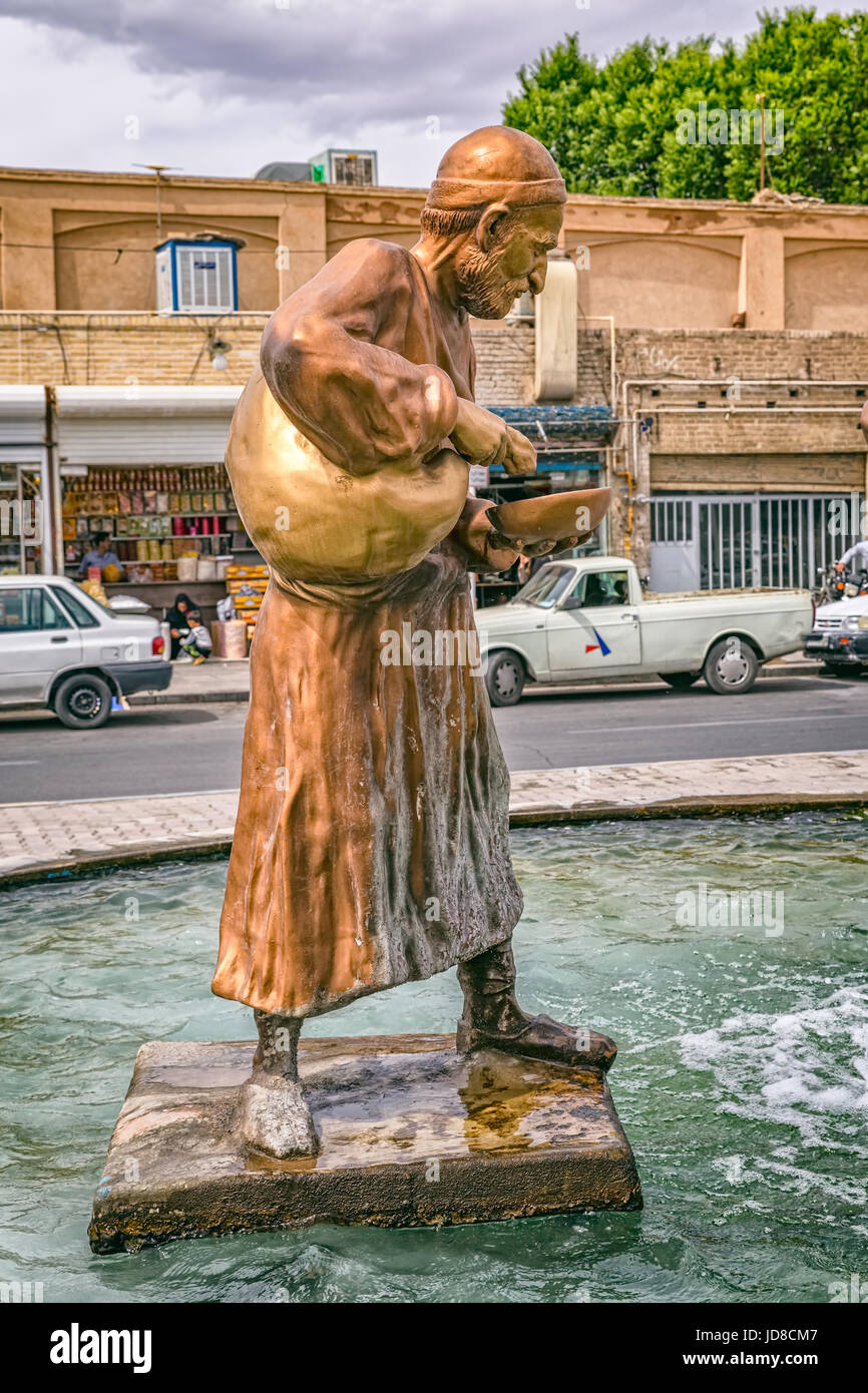 YAZD, IRAN - MAY 4, 2015: Fountain statue of old traveler in front of ...