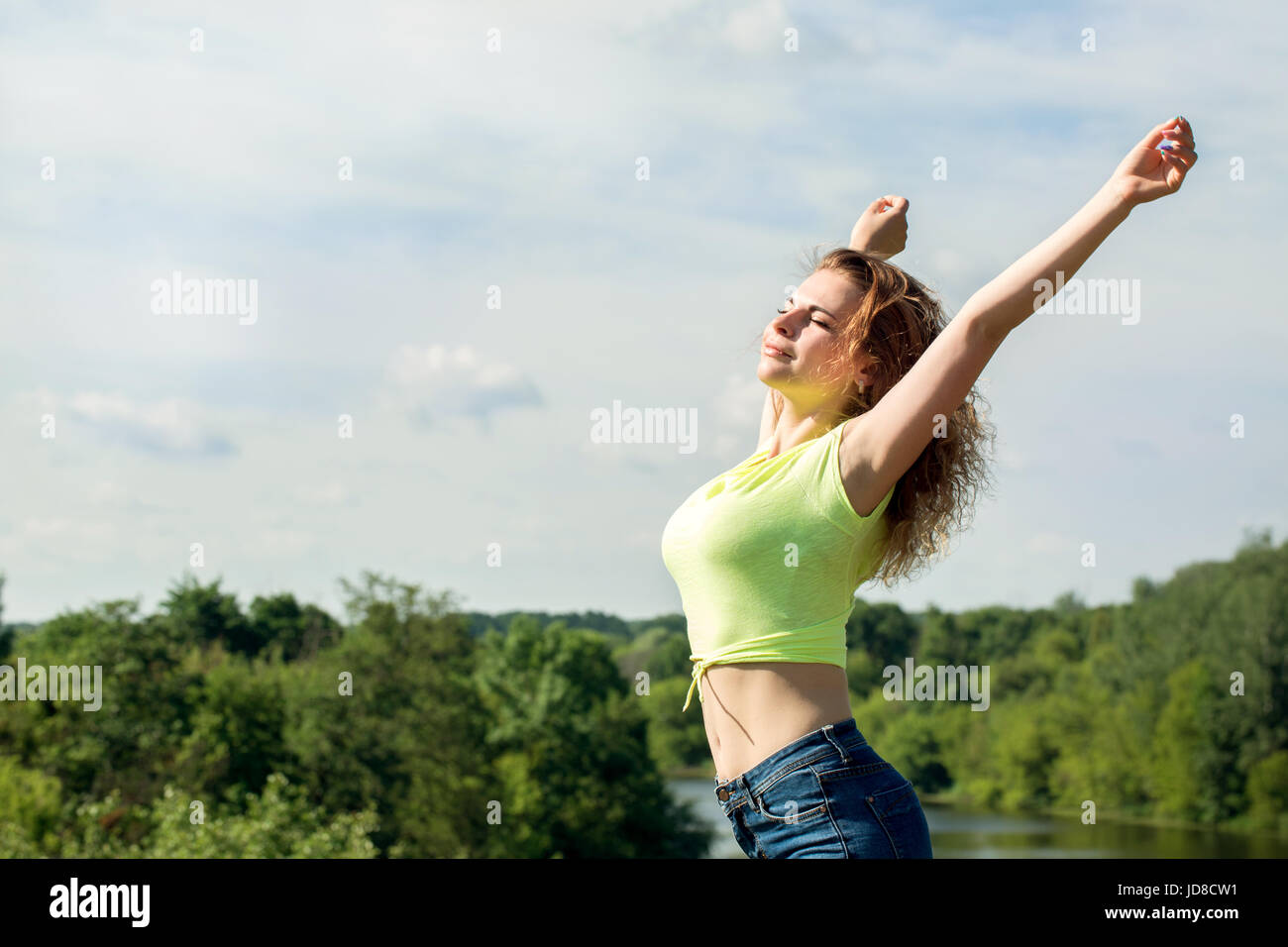 Woman raised her hands up Stock Photo - Alamy