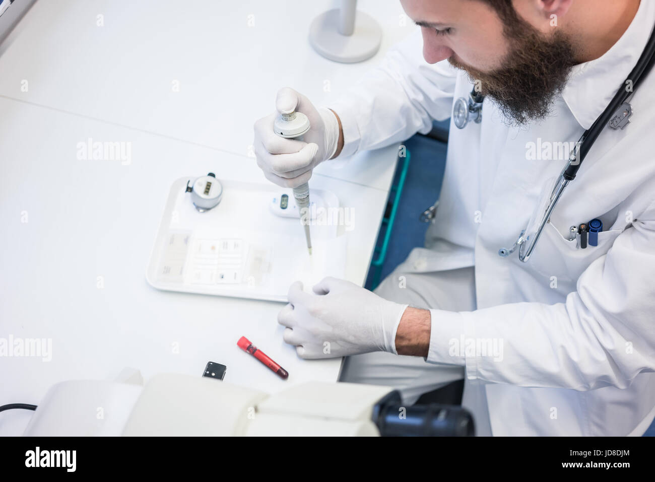 Doctor or scientist in lab performing medical test in glass tube Stock ...