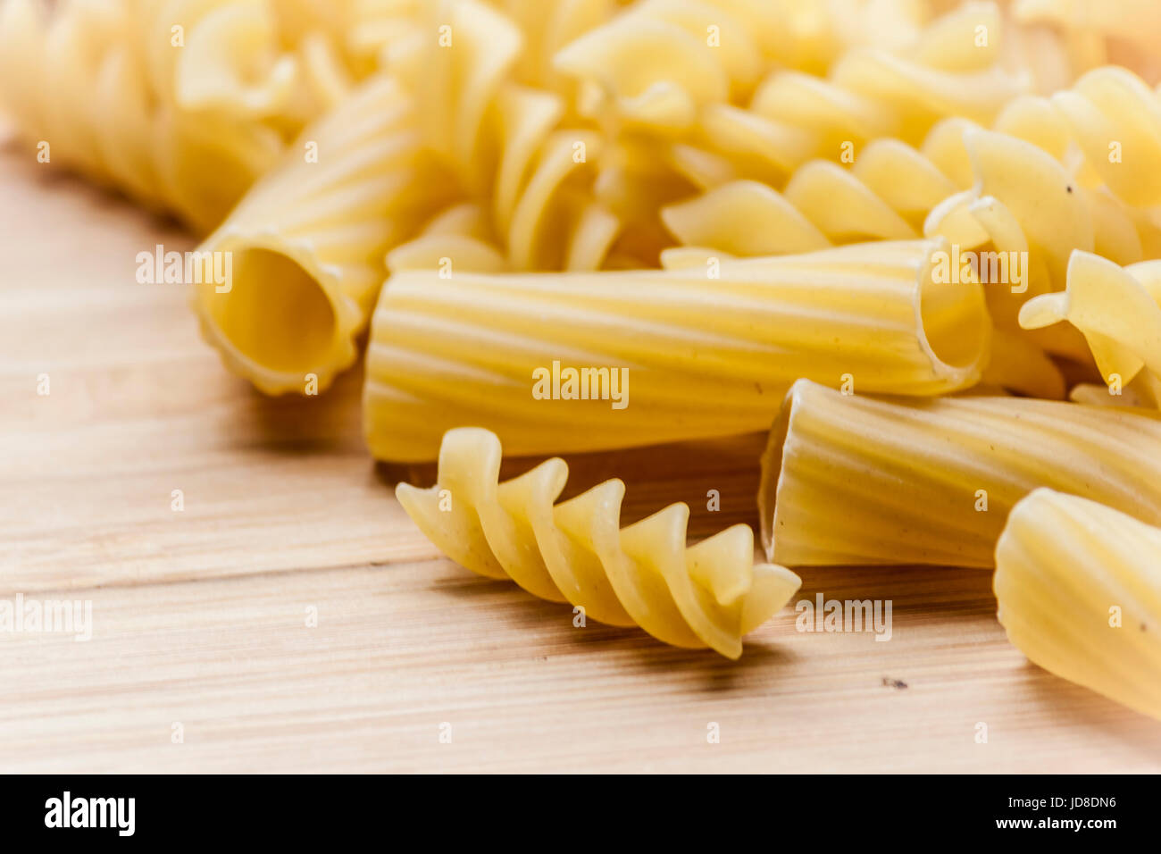 Italian pasta on a wooden table Stock Photo - Alamy