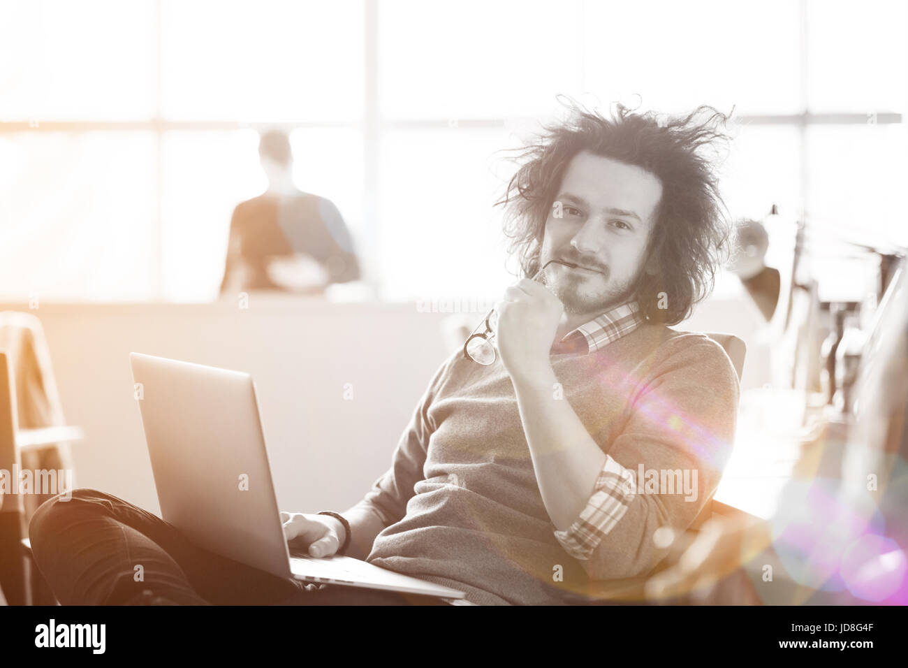 Young businessman programer in big bright office at work using computer ...