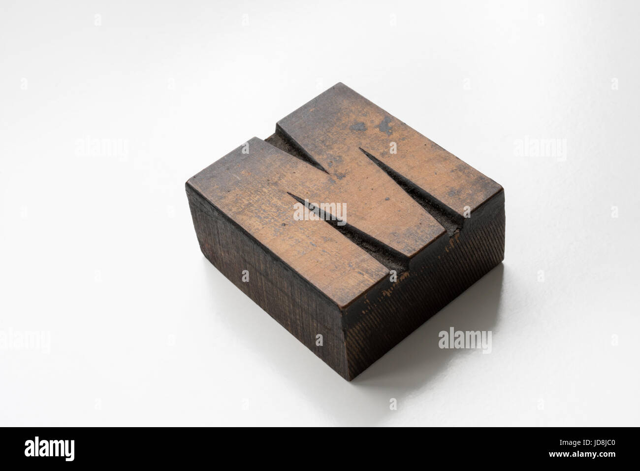 Old letterpress letter m printing block isolated on a white background ...