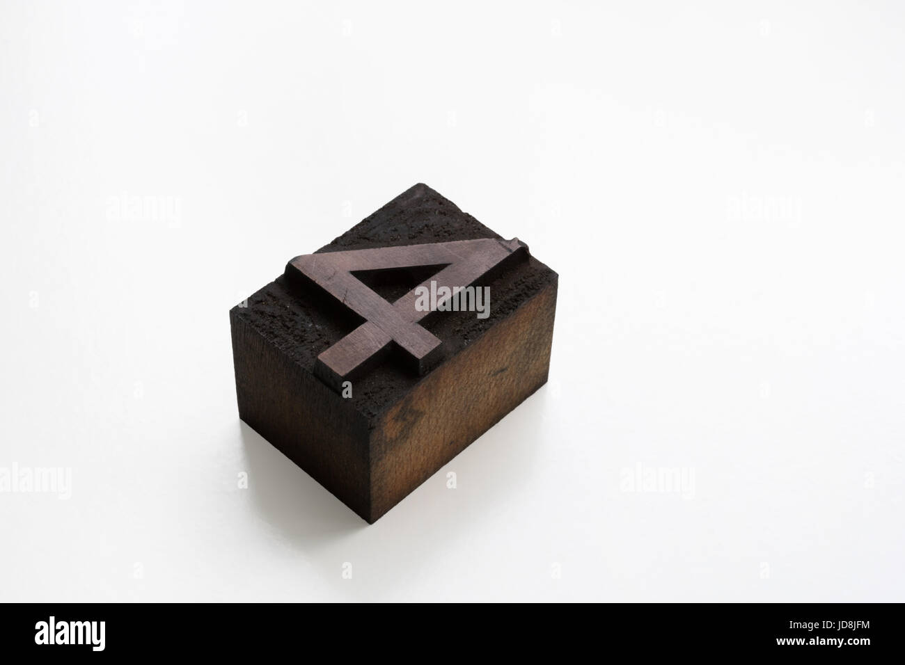 Old letterpress number 4 printing block isolated on a white background ...