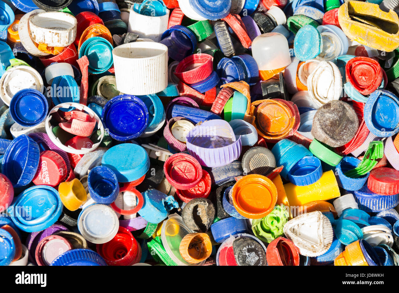 Brightly coloured plastic bottle tops - plastic waste and pollution ...