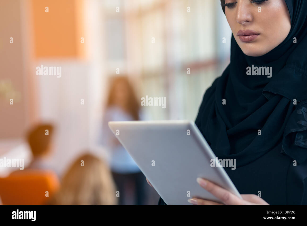 beautiful Arabian girl with tablet computer working at startup office ...