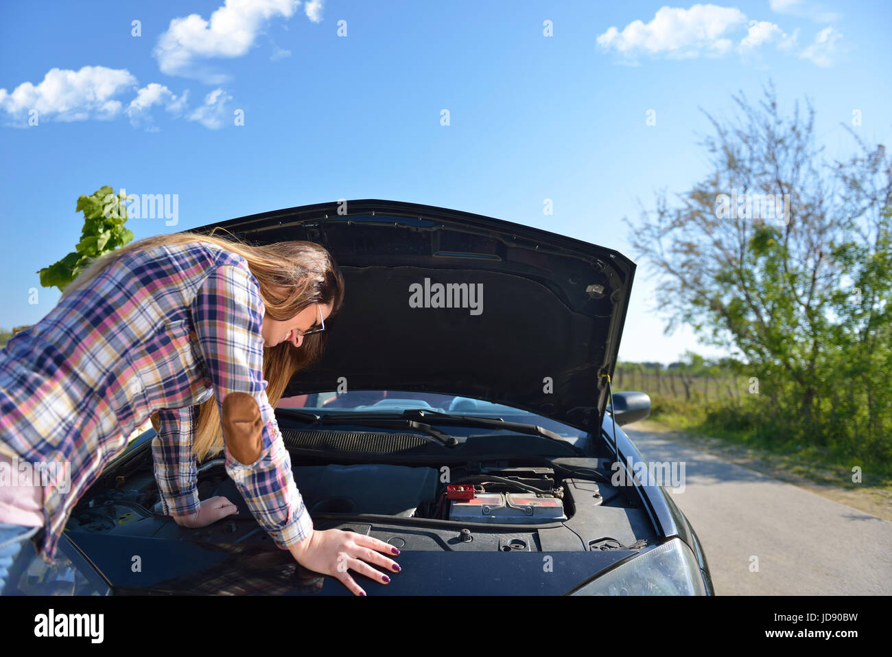 Women spection She opened the hood Broken car on the side See engines ...