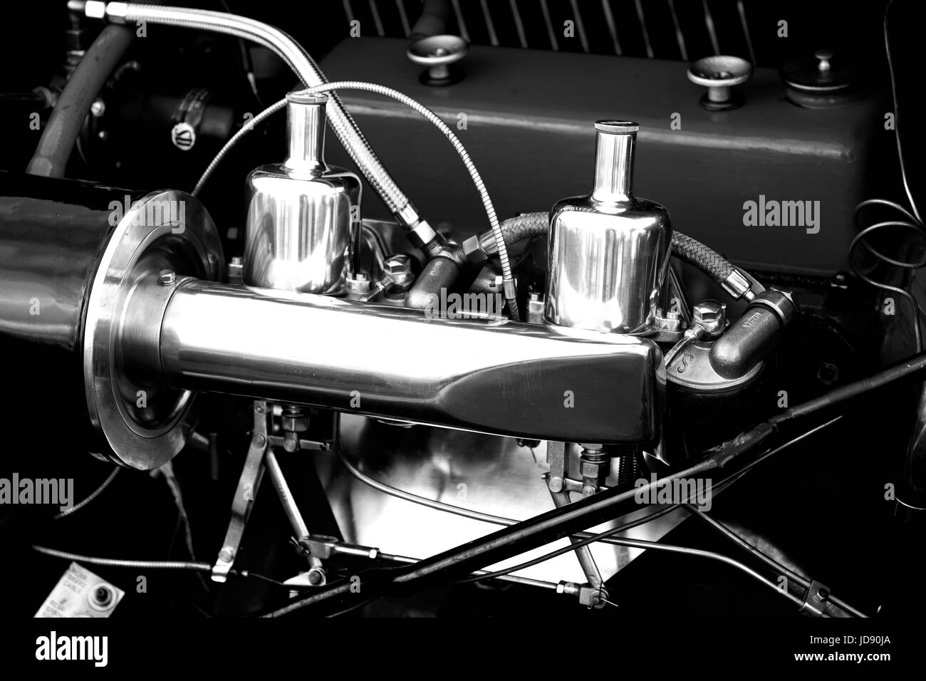 Bright shiny chrome carburettors inside the engine bay of a classic ...