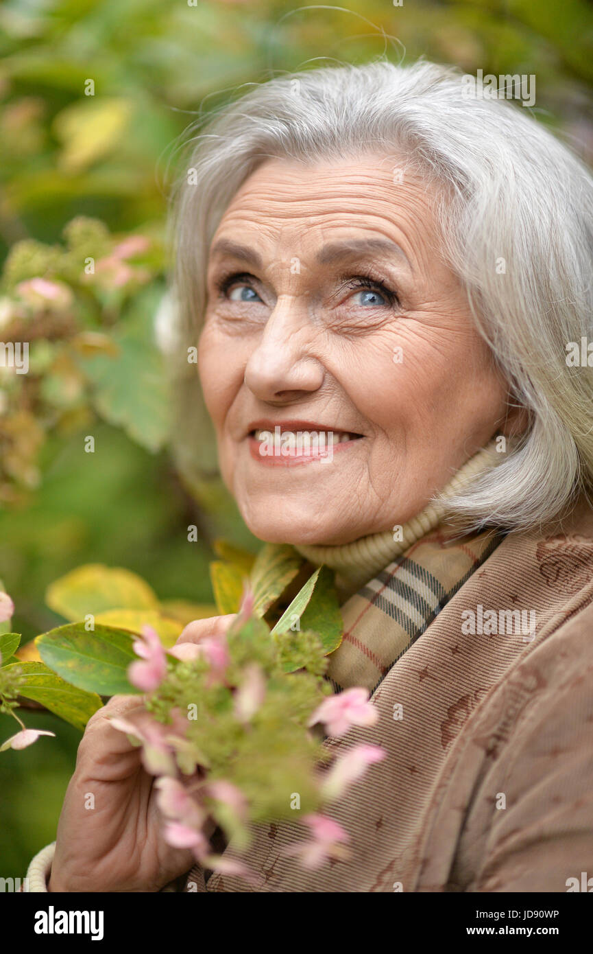 Portrait of a senior beautiful woman posing outdoors Stock Photo - Alamy