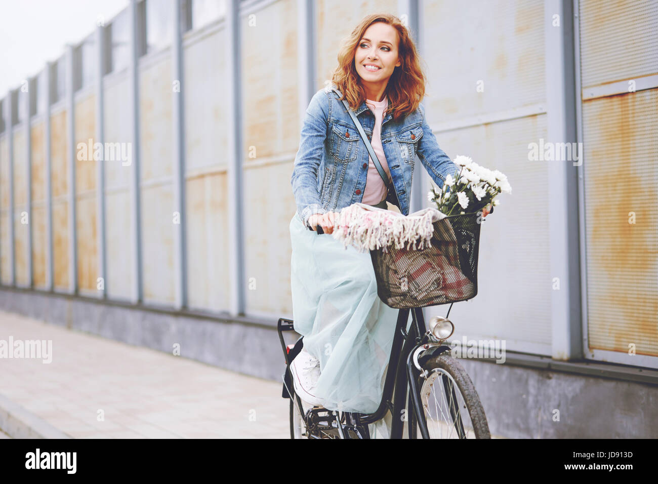 Beautiful woman riding a bike Stock Photo - Alamy