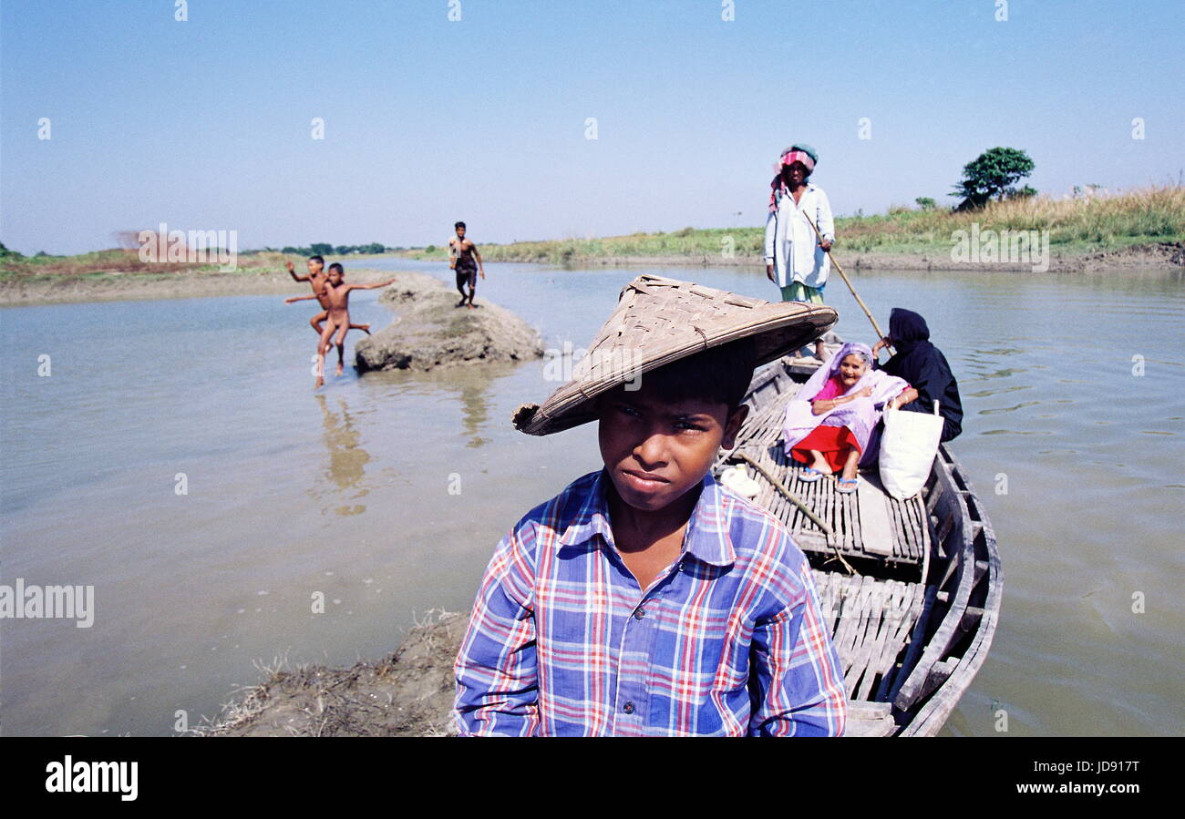 a child boat man with his father waiting for passengers in a small ...