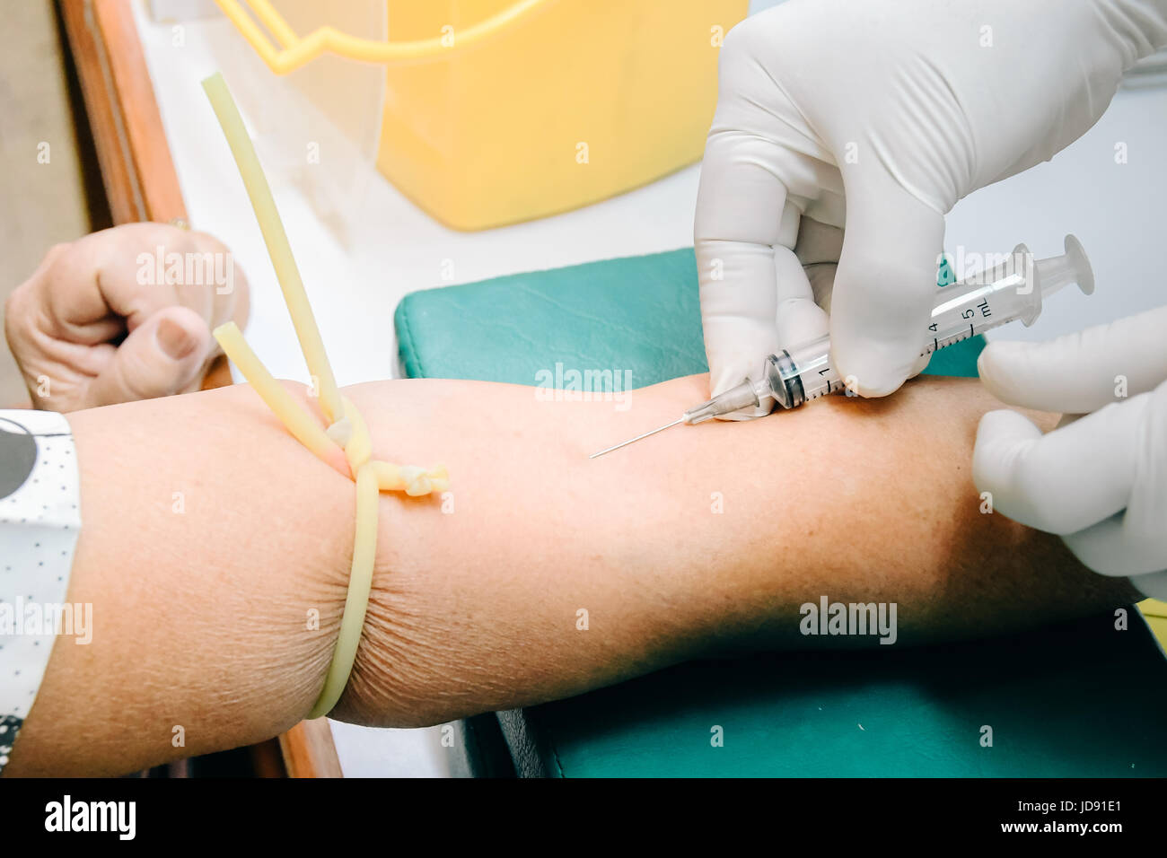 Doctor or nurse hands in medical blue gloves using needle syringe ...