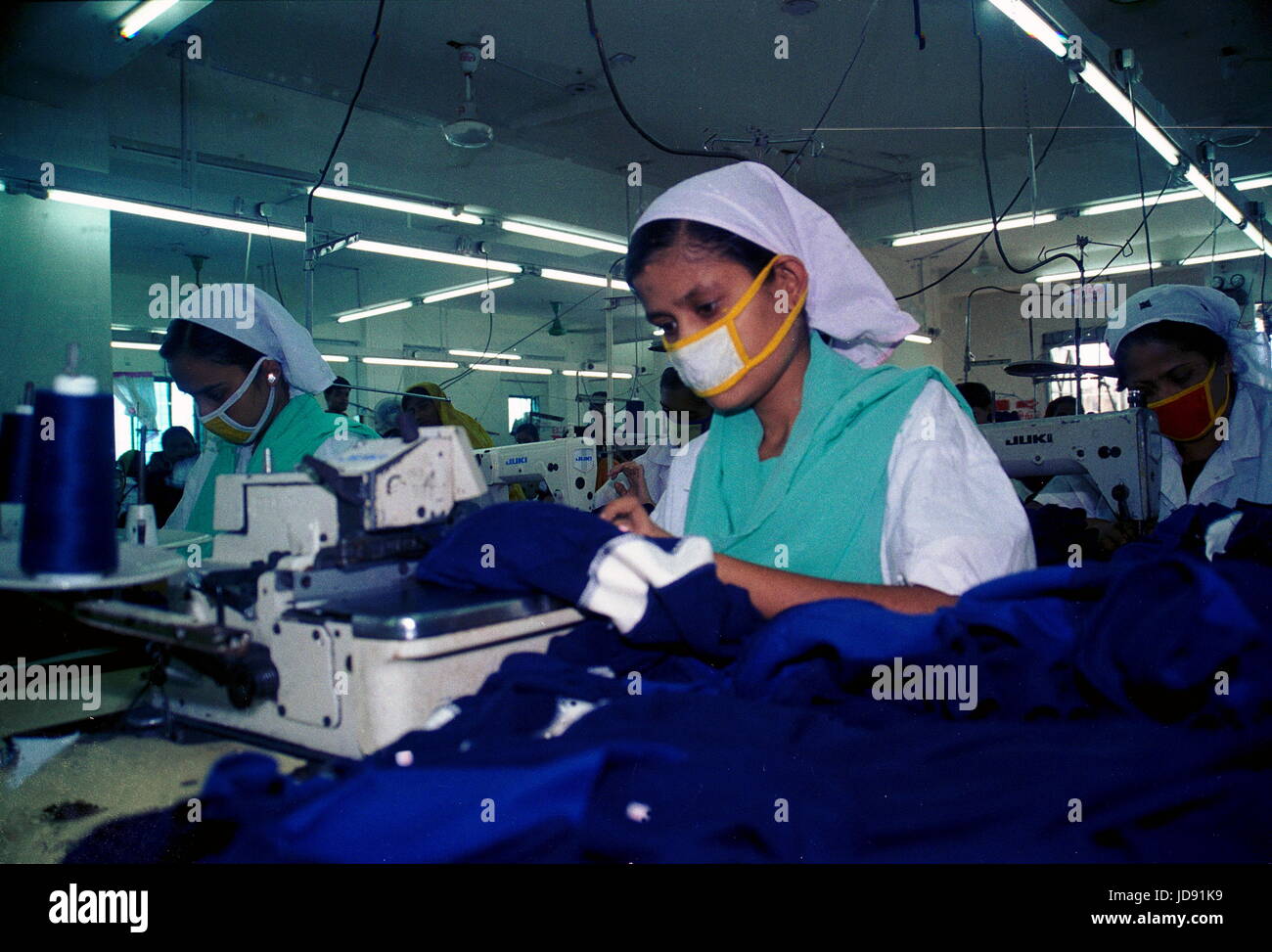inside of a garment industry , the women workers are passing the busy ...