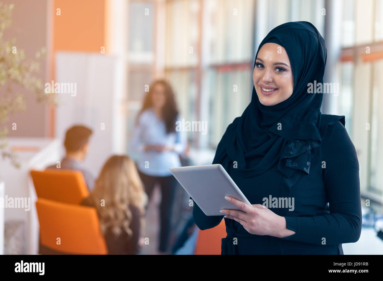 beautiful Arabian girl with tablet computer working at startup office ...