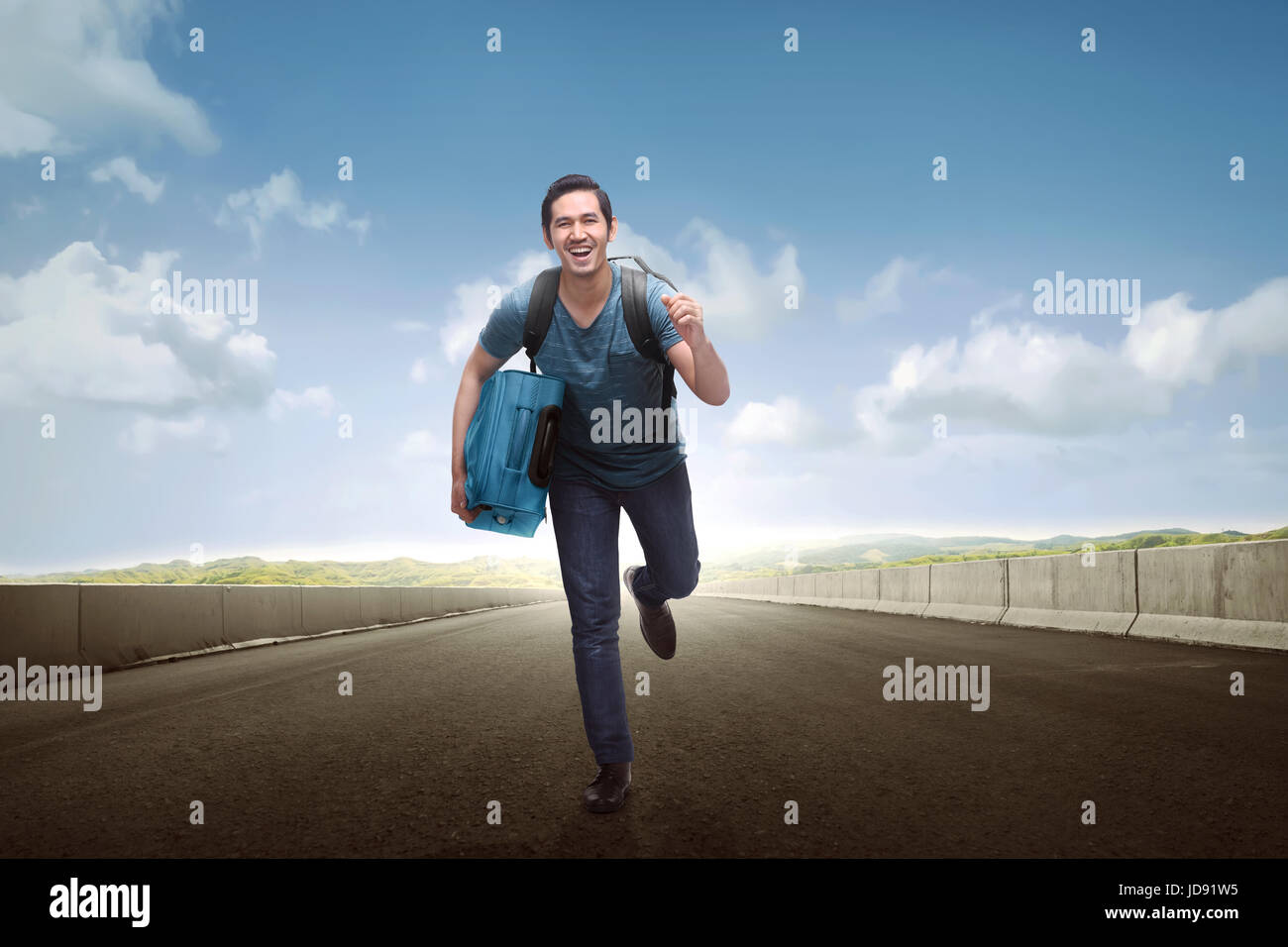 Young man running along road hi-res stock photography and images - Alamy