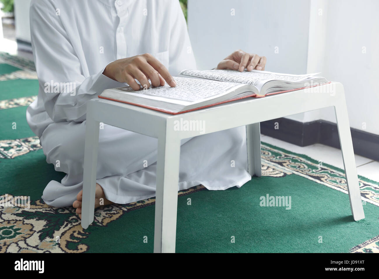 Muslim man sitting in prayer hi-res stock photography and images - Alamy
