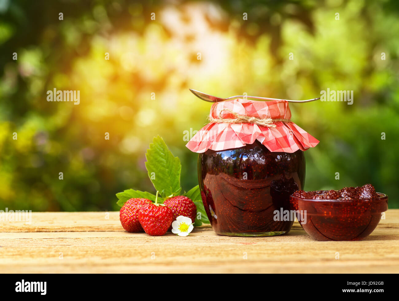 still life with strawberry jam on table with sunshine blurred natural ...