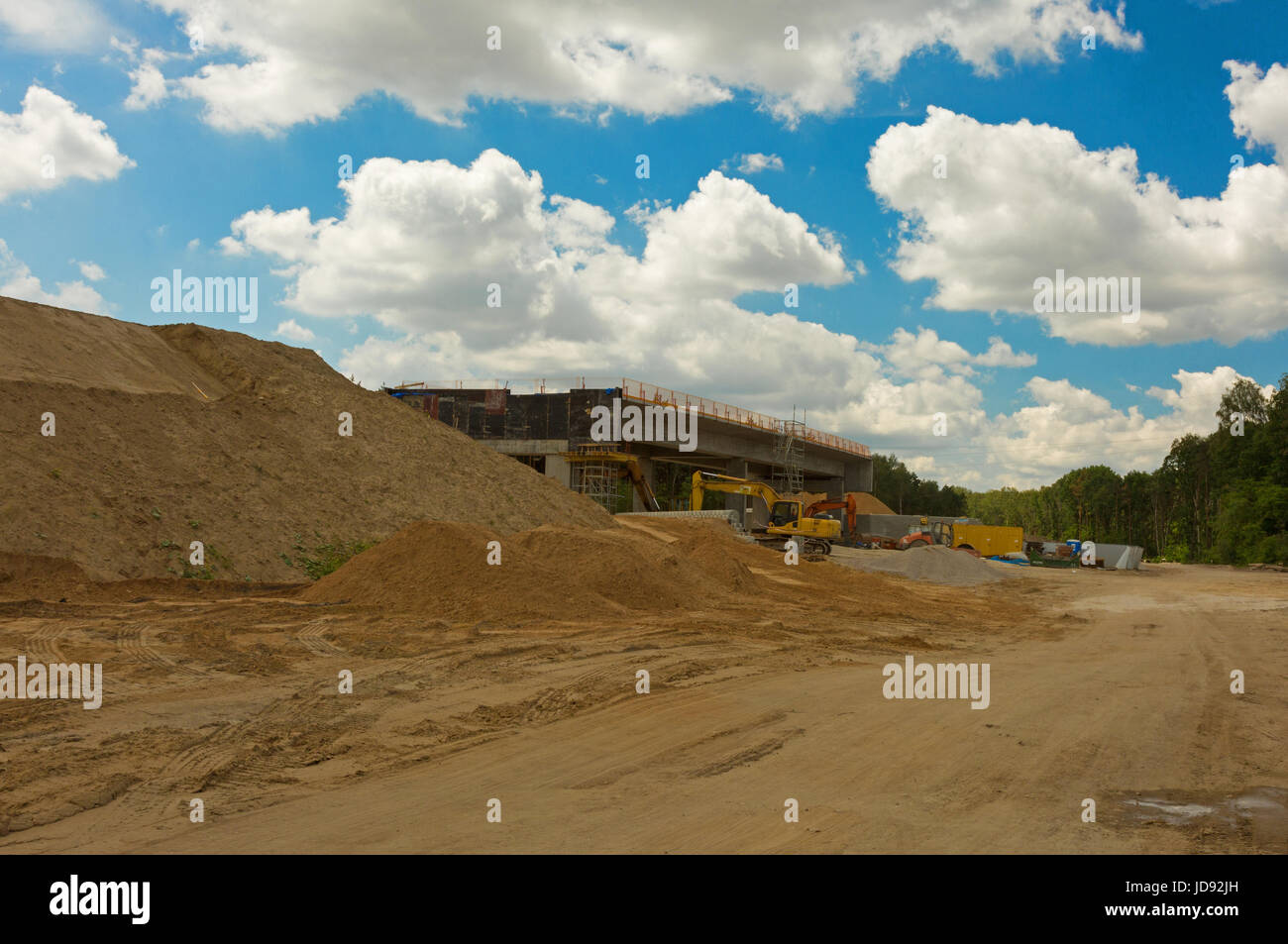 Construction site of a highway leading through the forest with visible ...