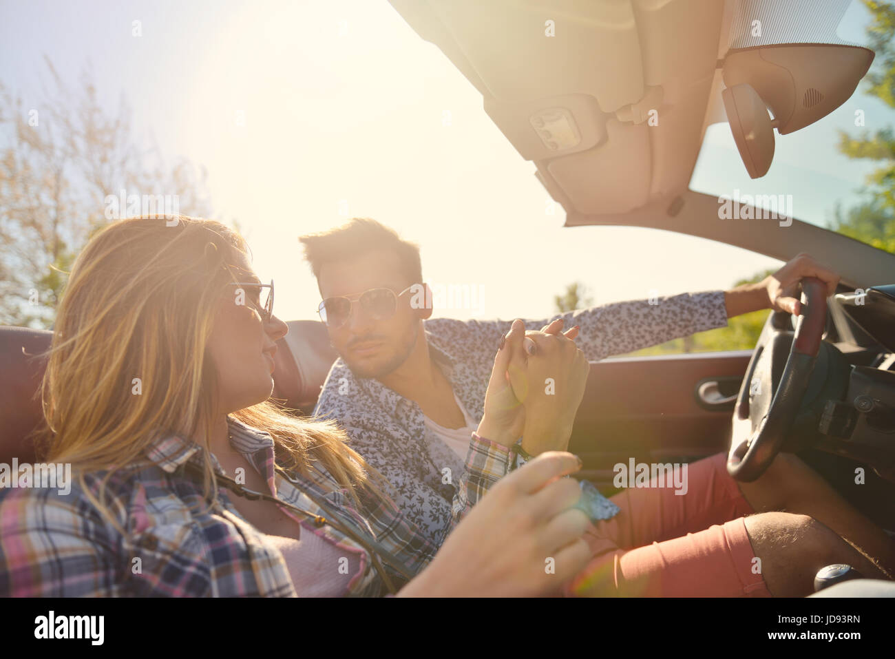 Couple of lovers driving on a convertible car - Newlywed pair on a ...