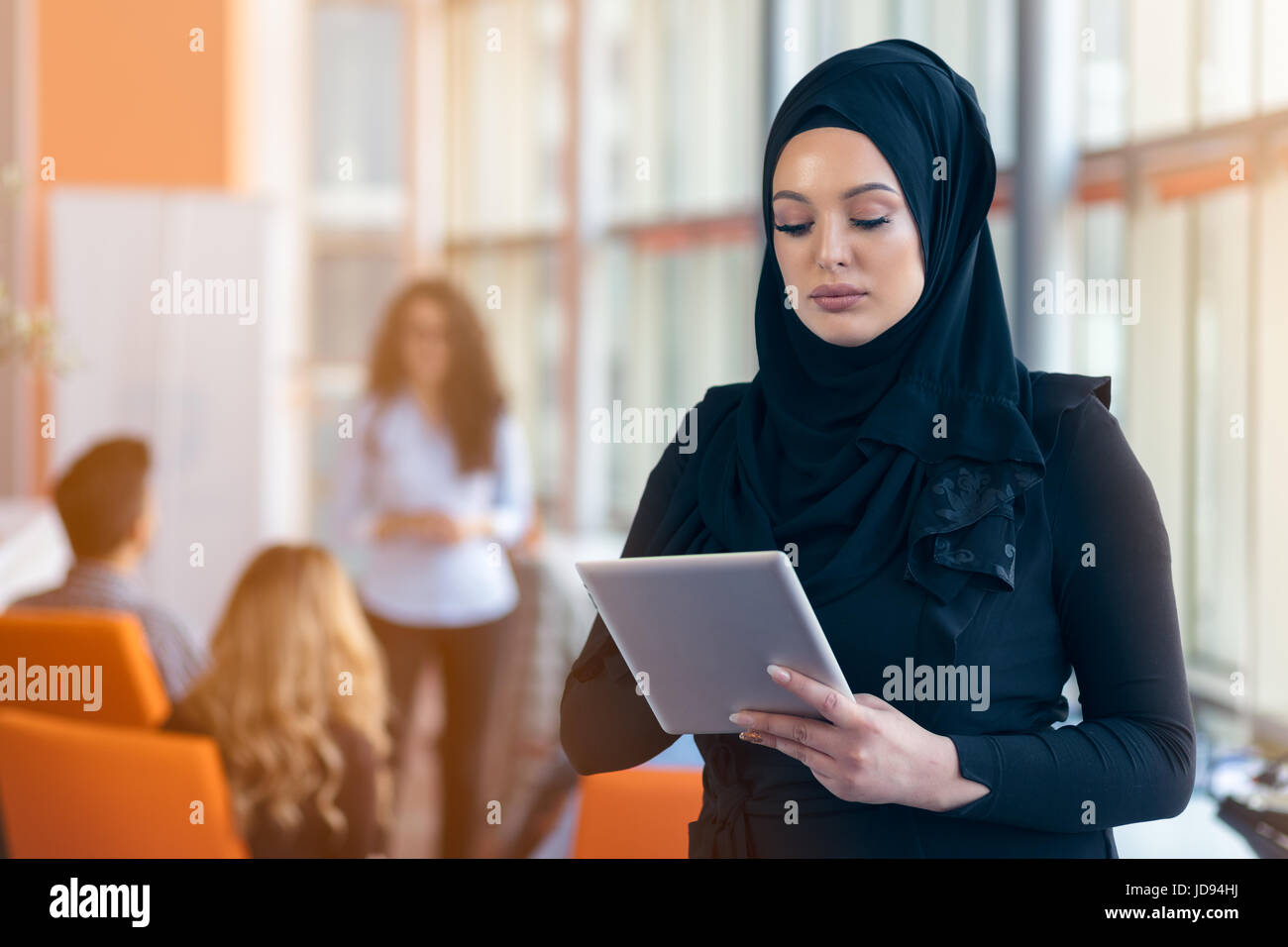 beautiful Arabian girl with tablet computer working at startup office ...