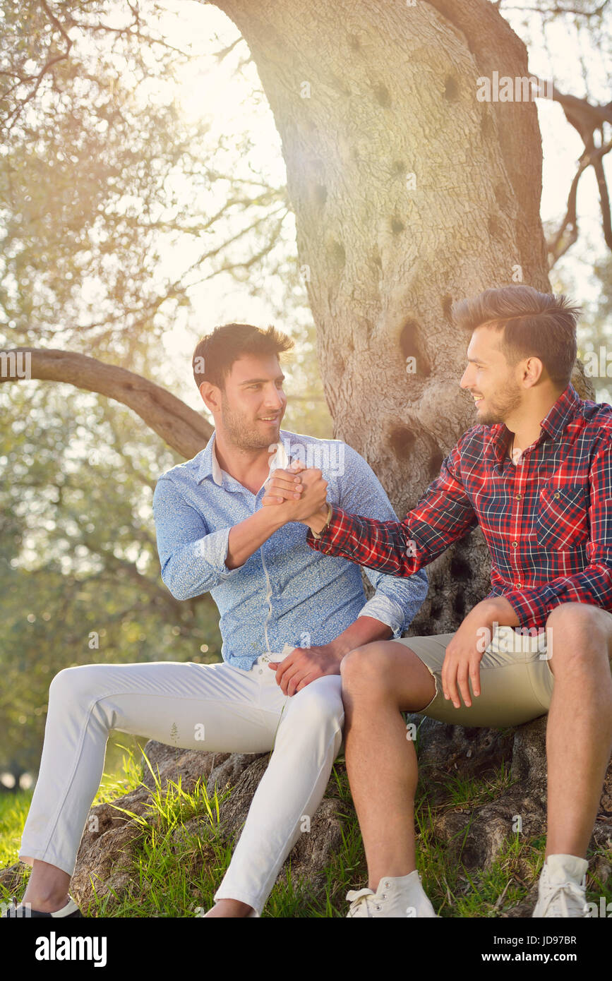 couple relax under the tree. Fine art style. Olive garden Stock Photo ...