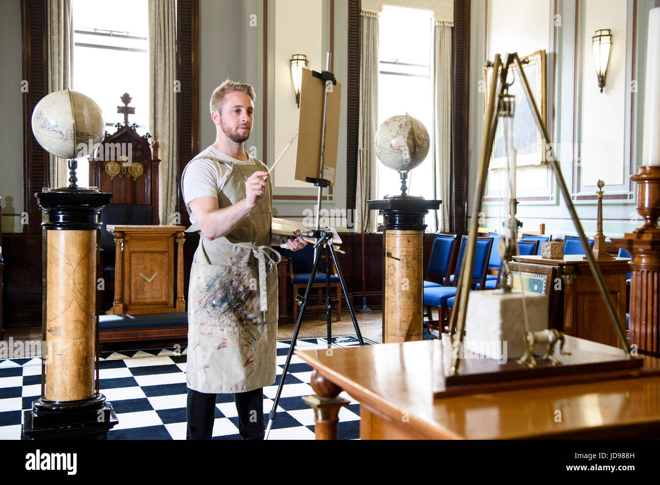 Artist Jacques Viljoen pictured working in Freemasons' Hall in central ...