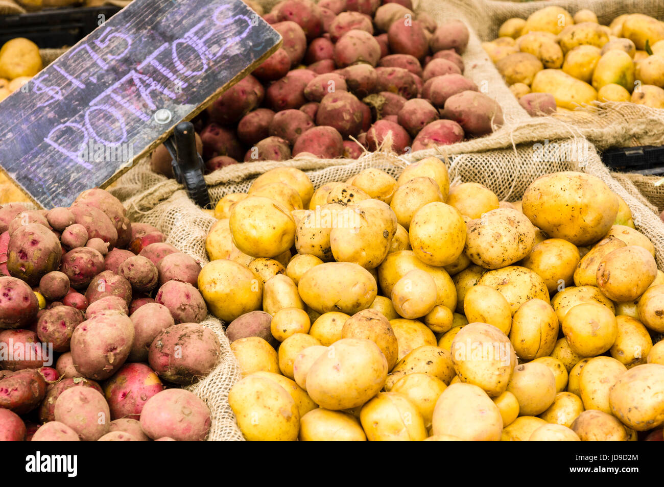 Display of red and white potatoes in boxes at the market Stock Photo ...