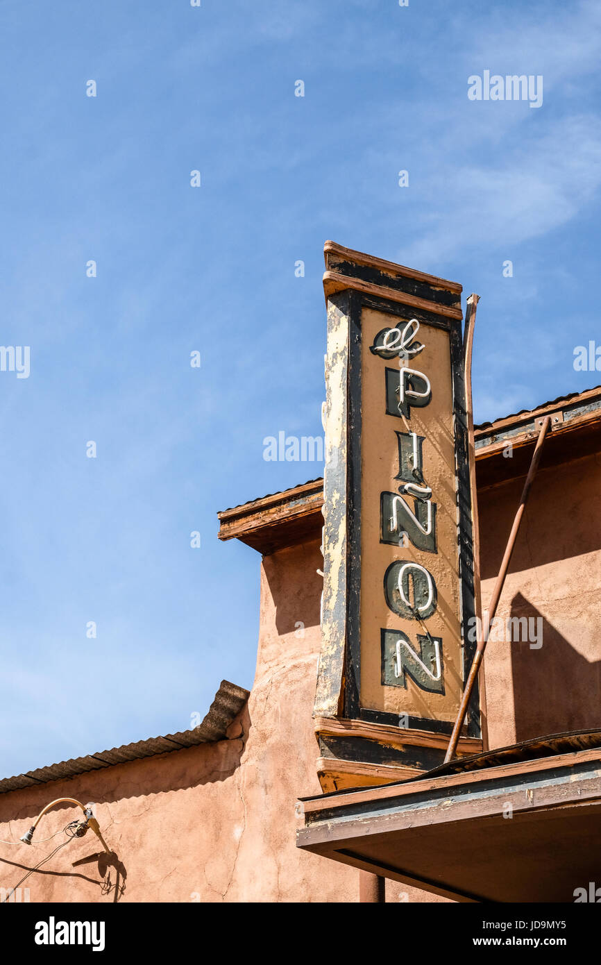 An old broken Pinon neon sign outside an abandoned mud house in New ...