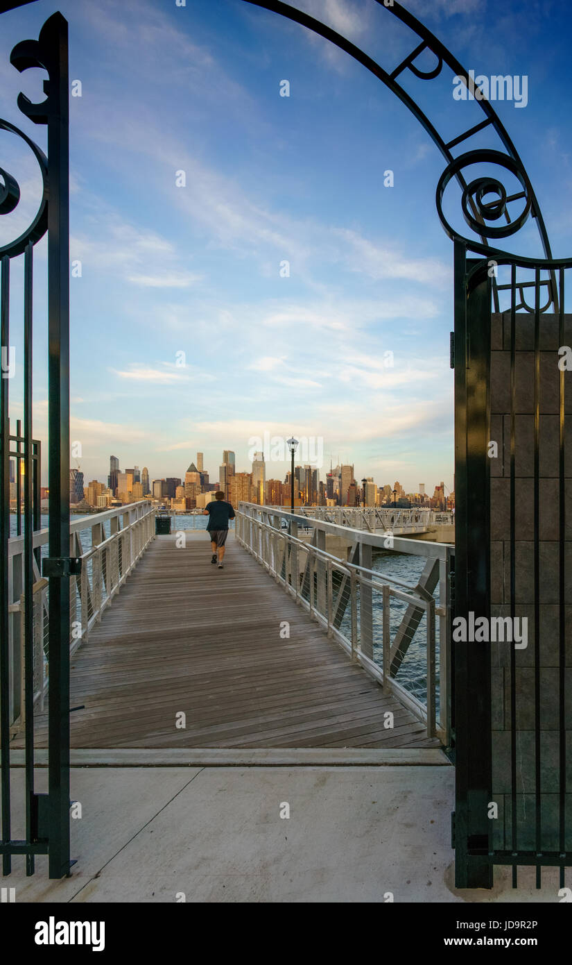 View through gates of man on boardwalk, New York, USA. 2016 urban city ...