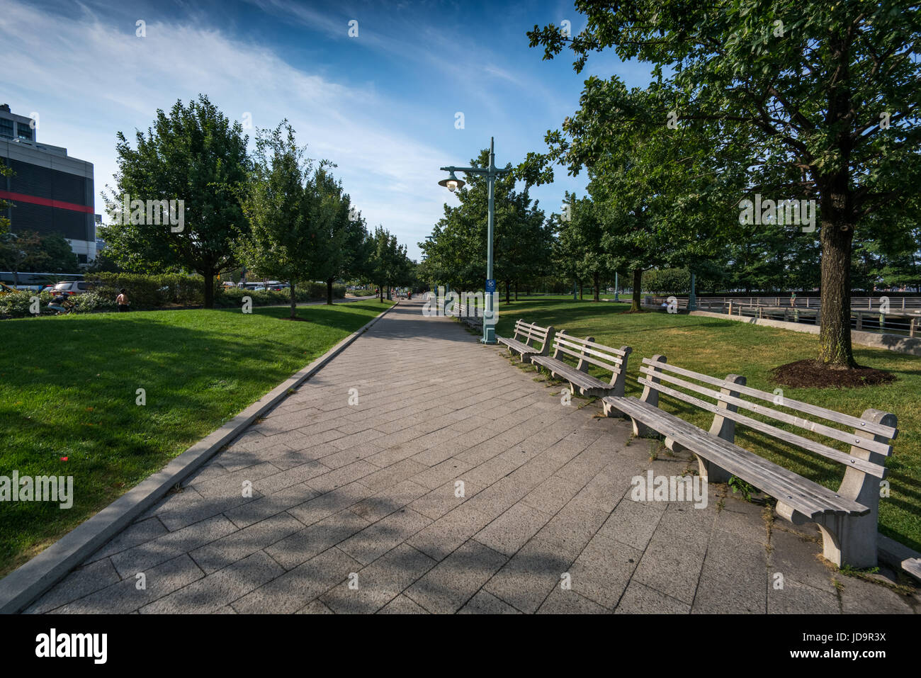 Footpath and empty benches in park with paving slabs, New York, USA ...