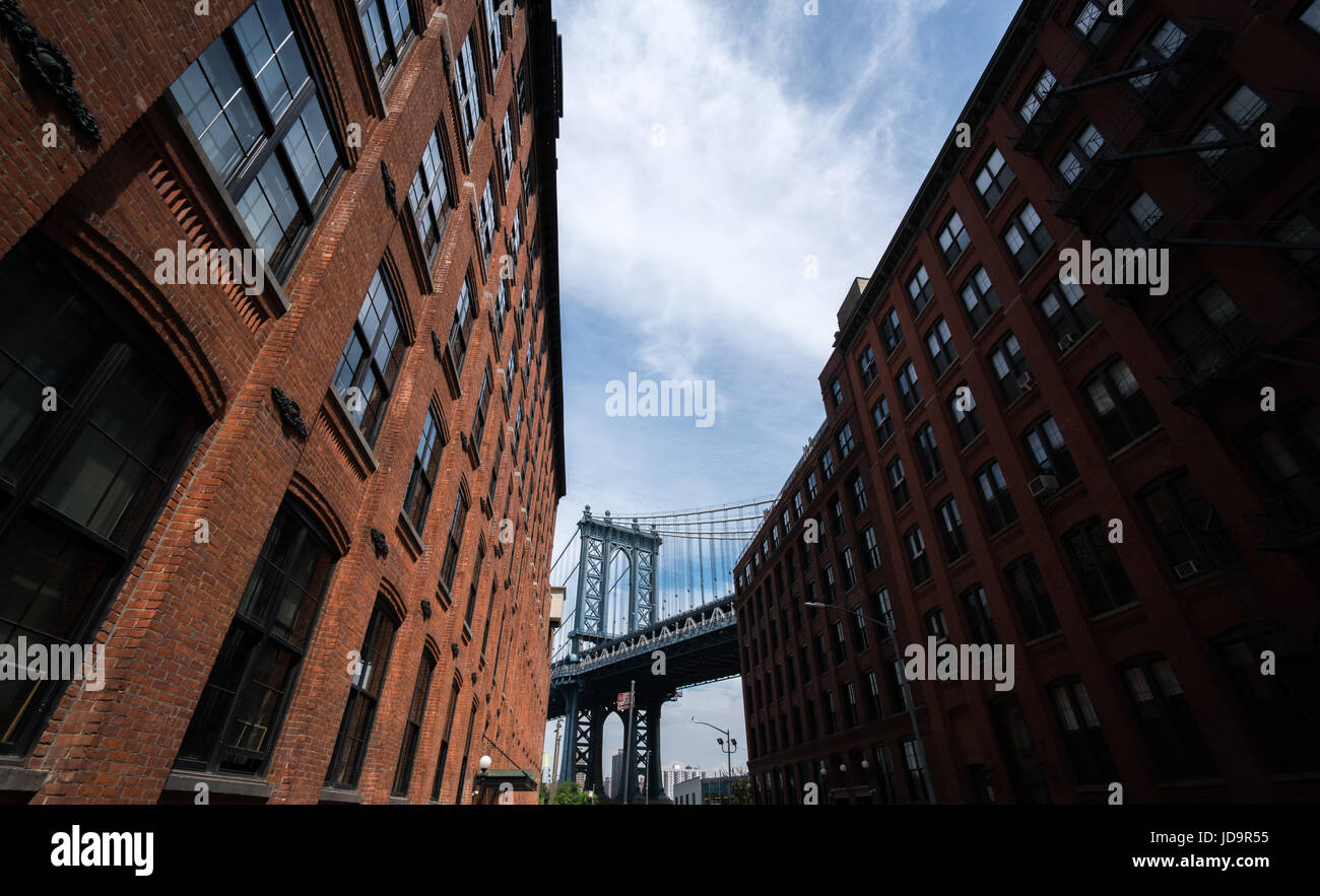 Low angle view of Manhattan Bridge seen through buildings, New York ...