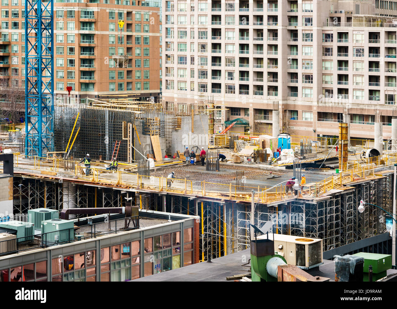 Urban scene, day, construction site with people working on roof Stock ...