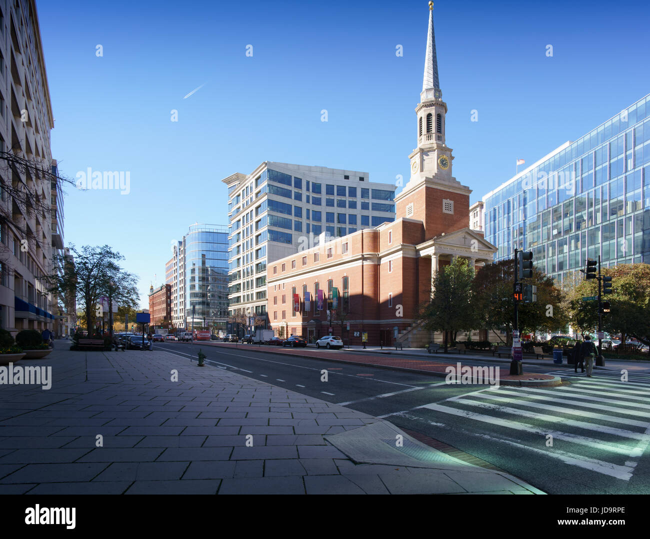 Street view of church with spire against blue sky, Washington DC, USA ...