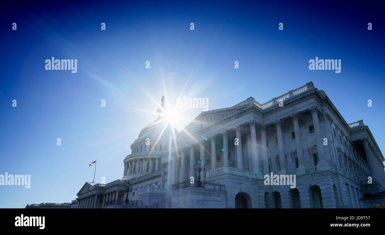 Capitol building exterior against clear blue sky and lens flare ...