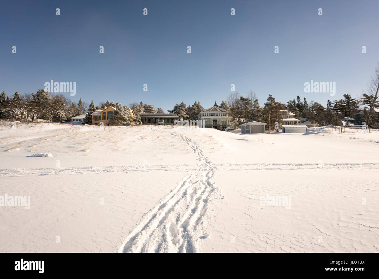 Footprints leading through snow, heading towards house in distance ...