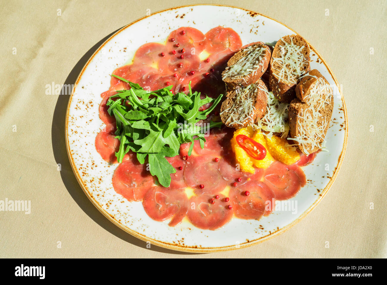 Duck carpaccio with toasts, parmesan and arugula Stock Photo - Alamy