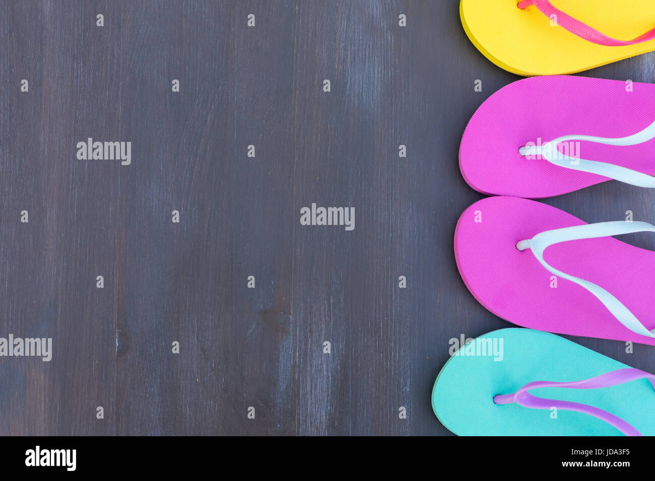 Summer beach fun - border of flip flop sandals, copy space on dark ...