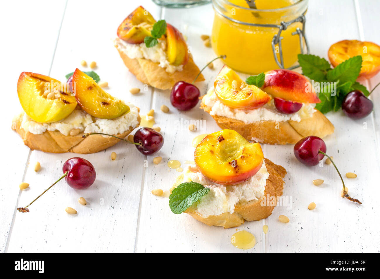 Homemade fresh sweet toasted toast with fruit. Peach and cherry ...
