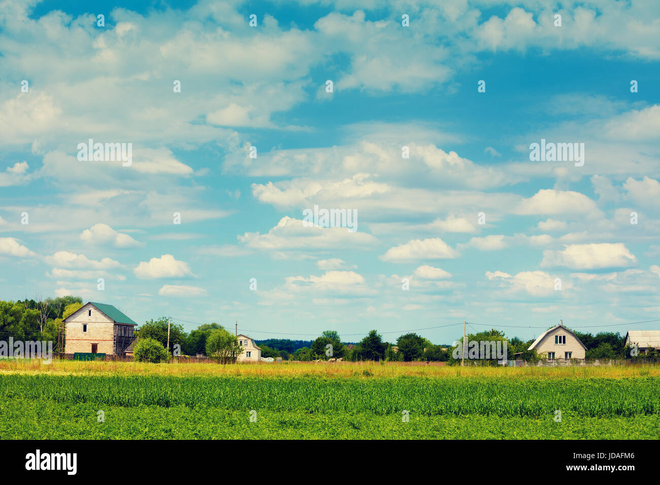 Rural landscape, field with blue sky and village Stock Photo - Alamy