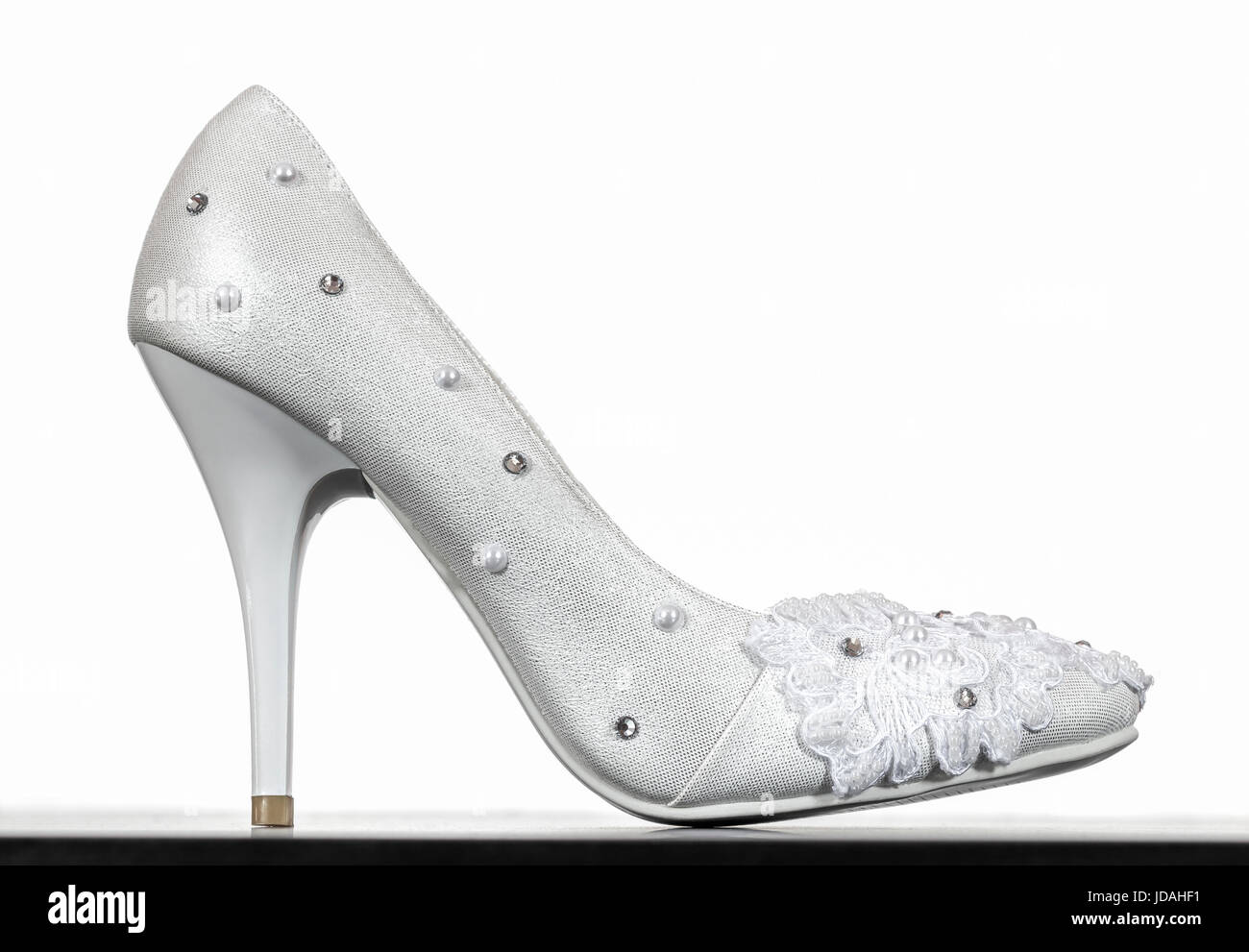 A female white wedding shoes closeup on white background Stock Photo ...
