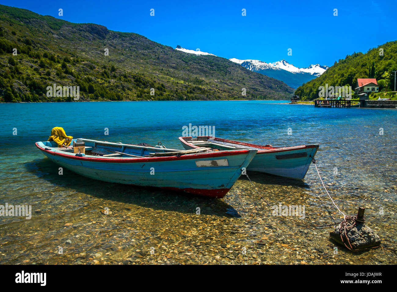 Small boats on the riverbank in Patagonian Andes Stock Photo - Alamy