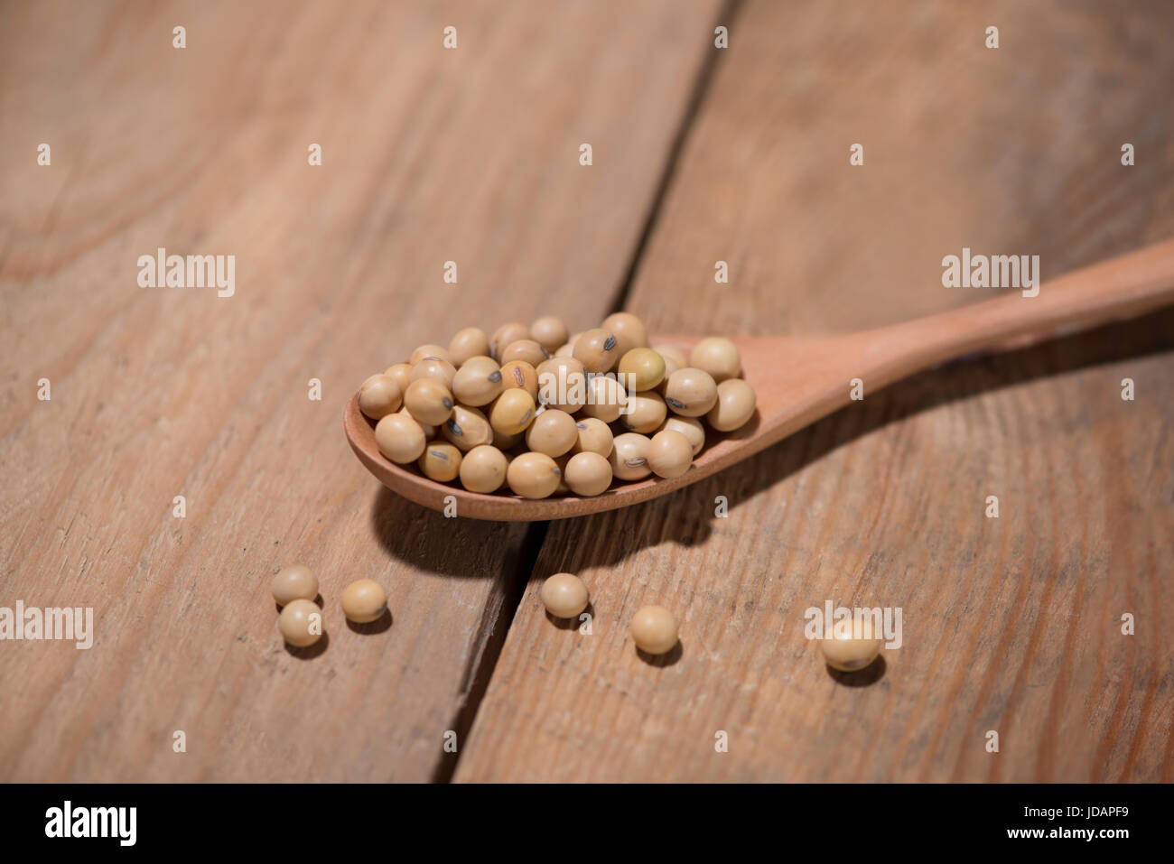Soya beans in spoon on wooden table Stock Photo - Alamy