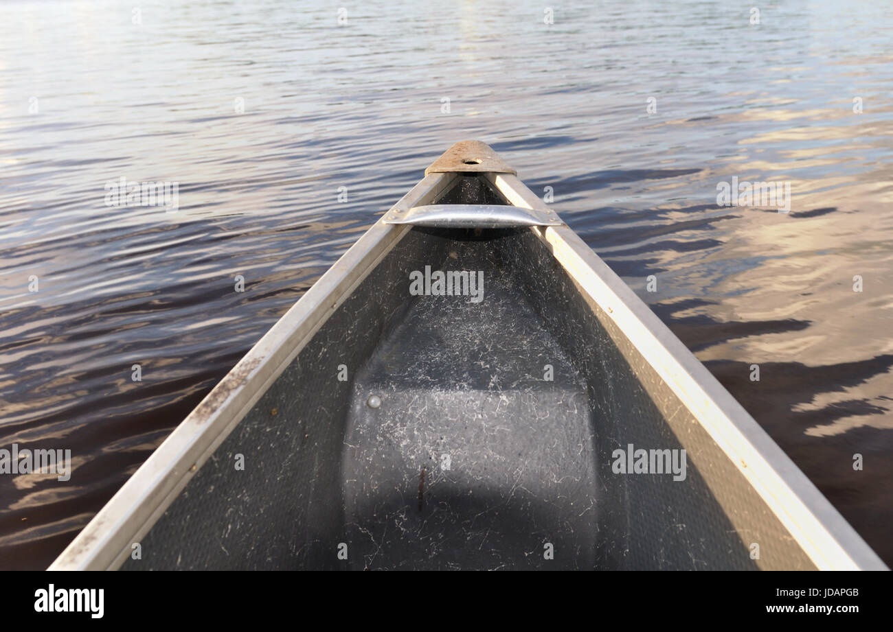 in front of a canoe navigate on a peaceful water of a lake Stock Photo ...