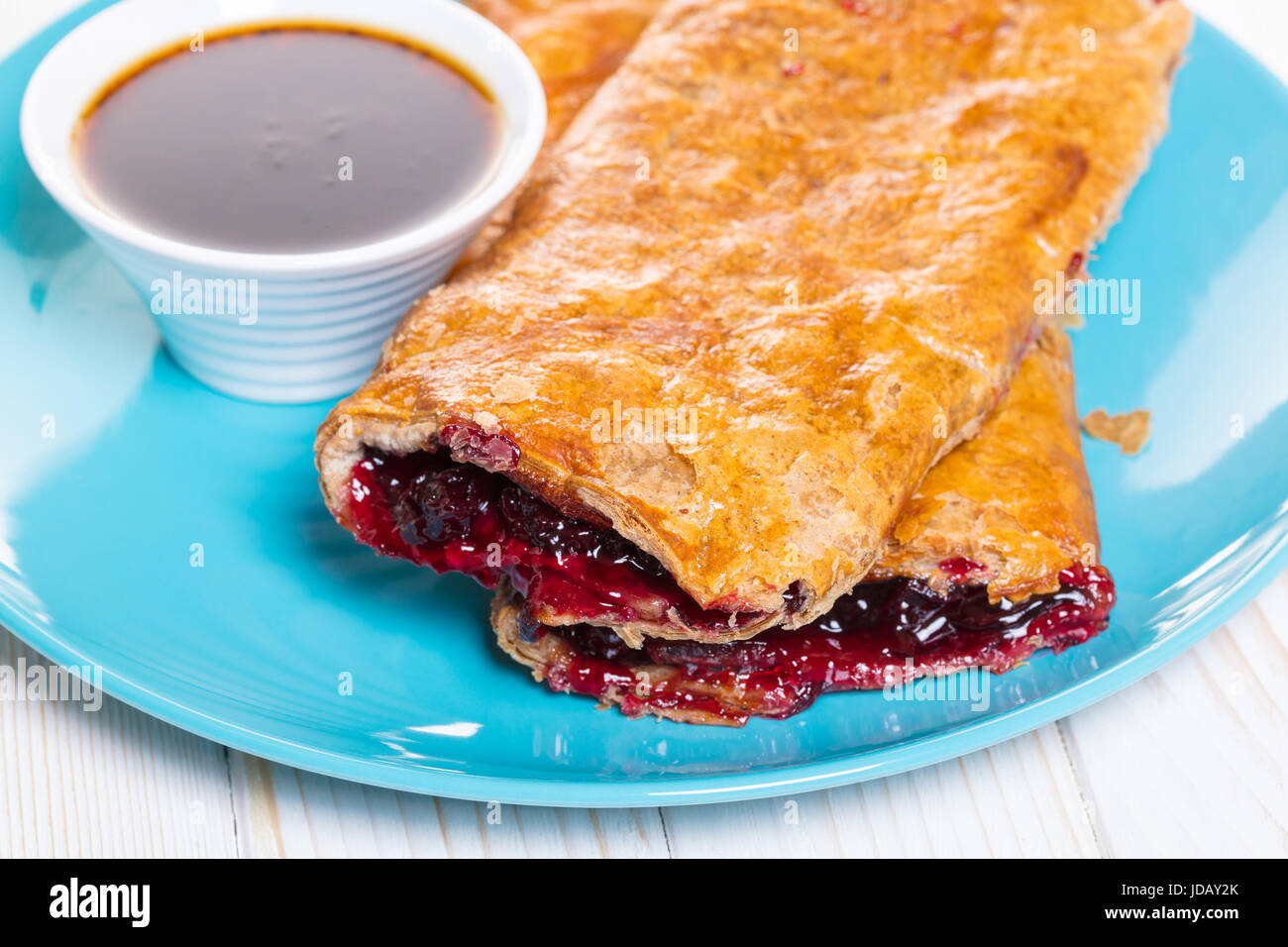 Baking, cherry strudel in a plate on wooden white background Stock ...