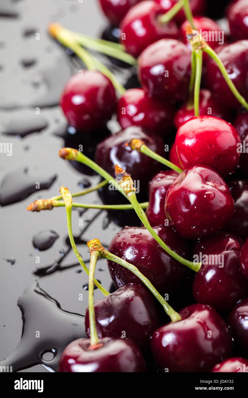 Ripe cherry on a black background with drops of water Stock Photo - Alamy
