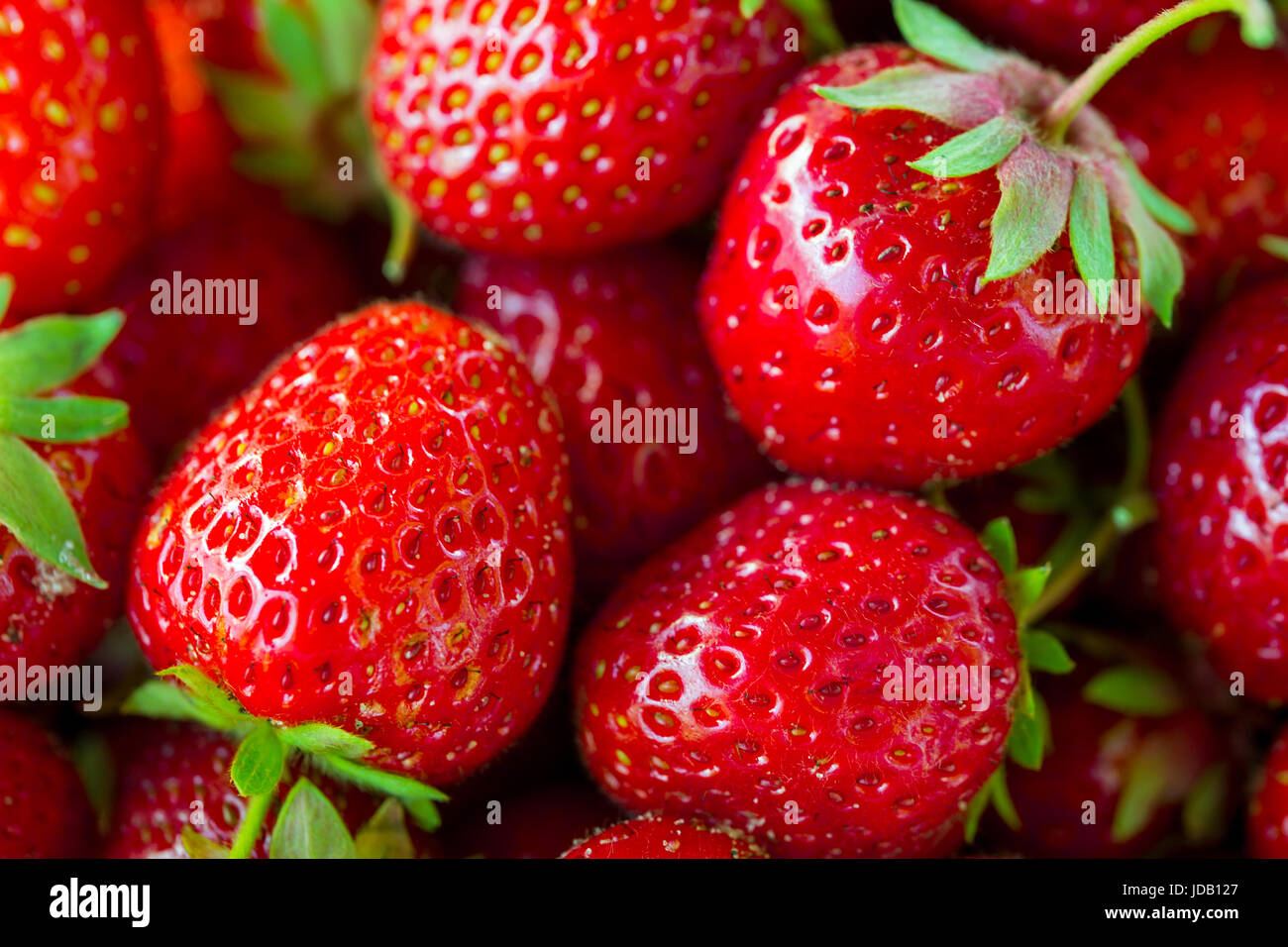 Fresh red strawberry closeup, background Stock Photo - Alamy