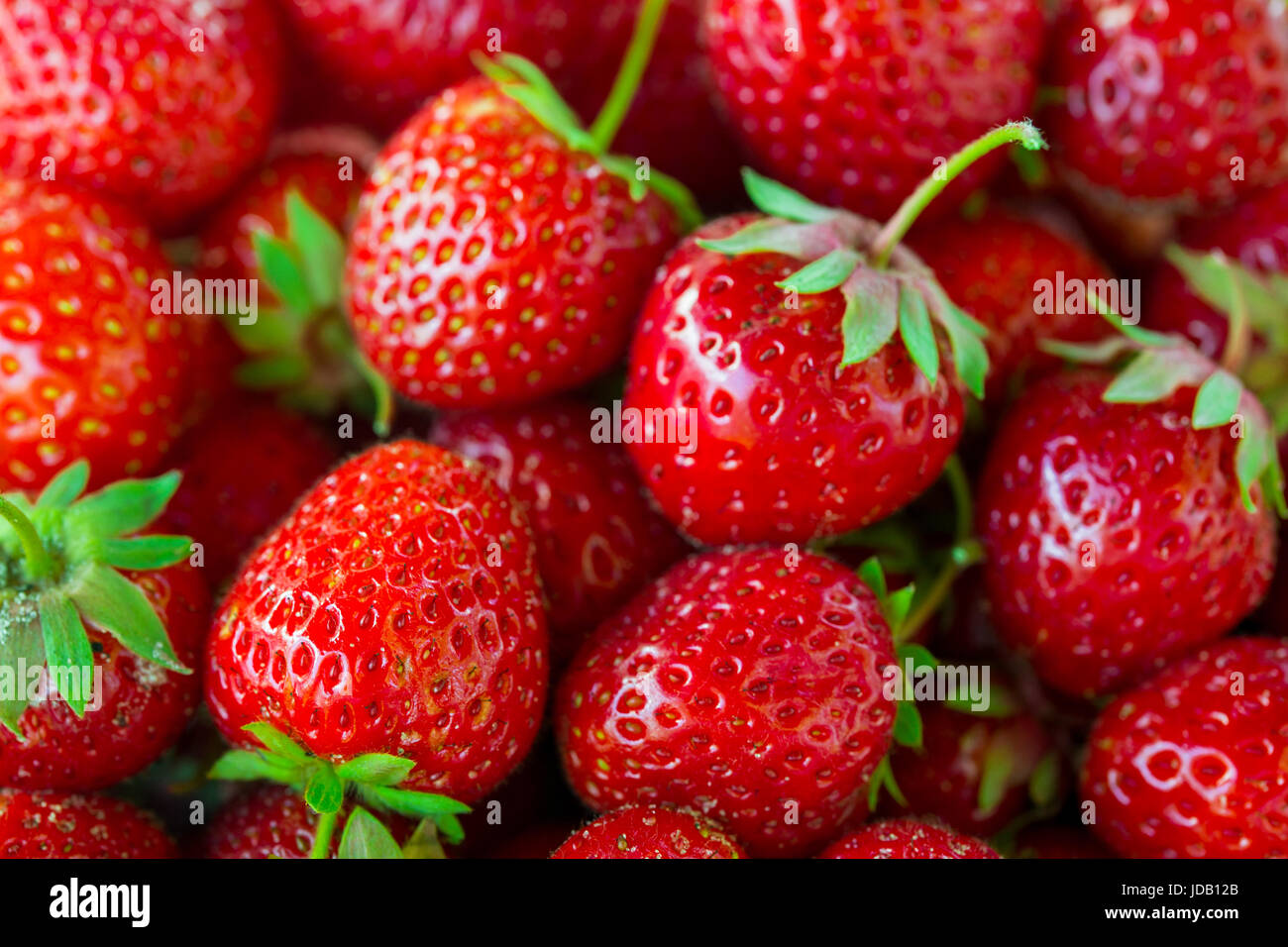 Fresh red strawberry closeup, background Stock Photo - Alamy