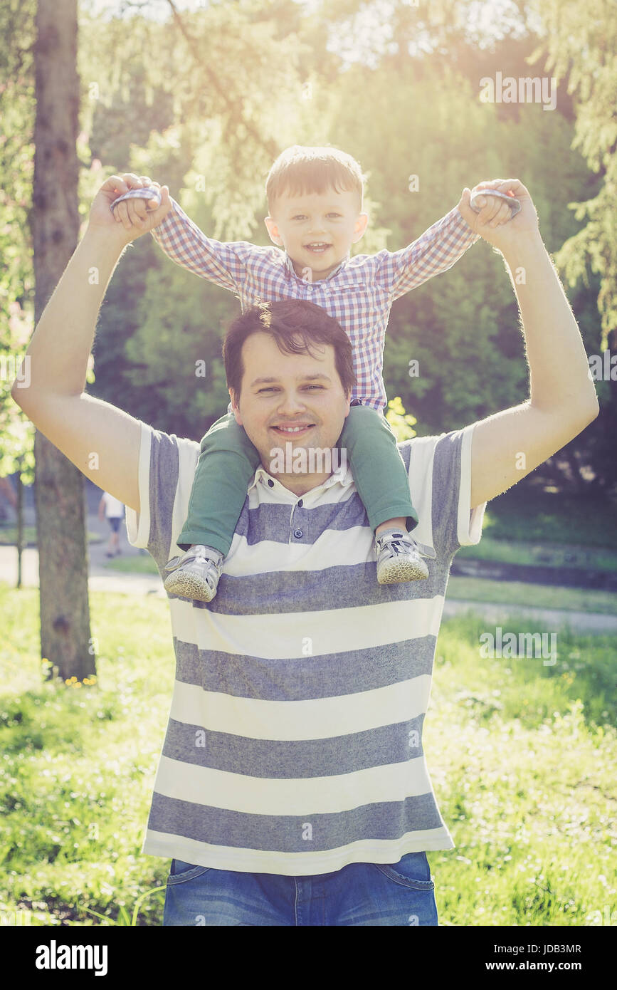 Child on dads shoulders hi-res stock photography and images - Alamy