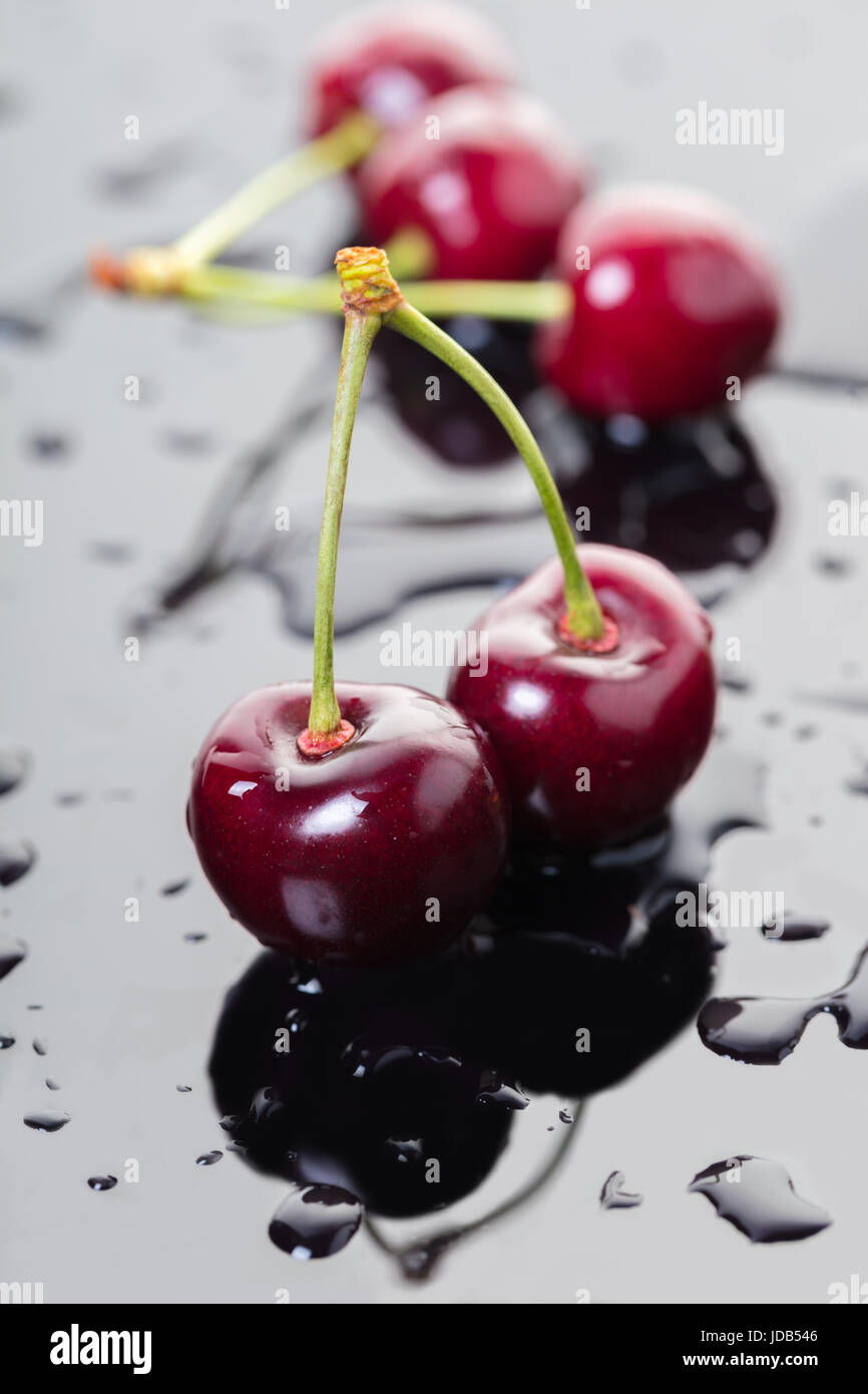 Ripe cherry on a black background with drops of water Stock Photo - Alamy