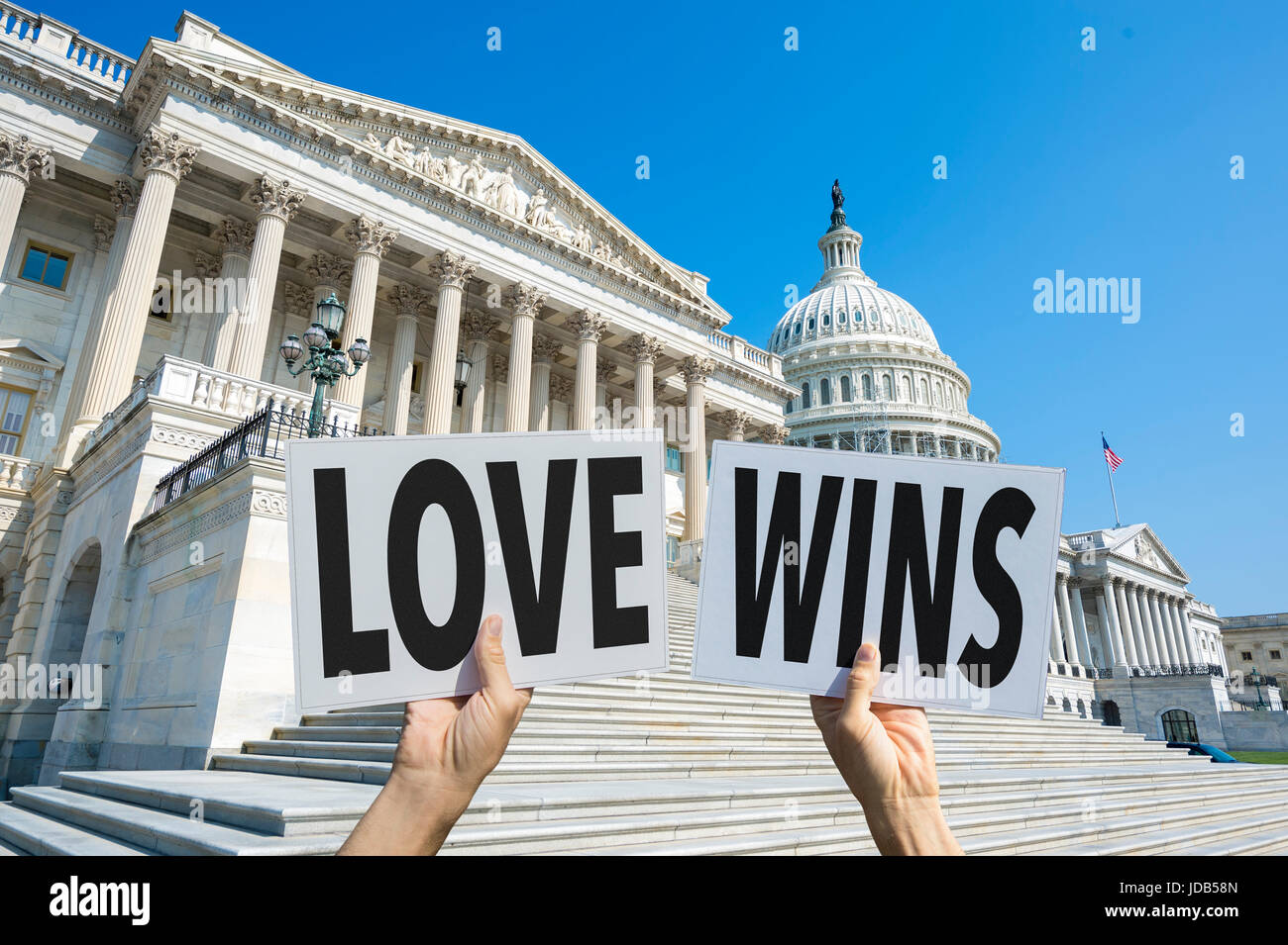 Hands of political protesters holding signs of the positive message ...