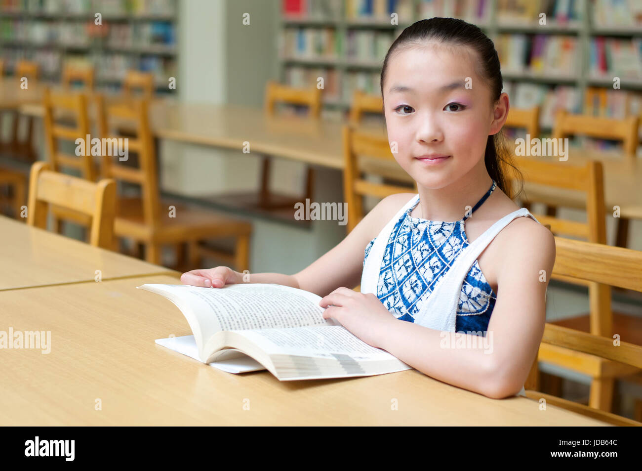 Pretty girls reading in the library, very serious study Stock Photo - Alamy